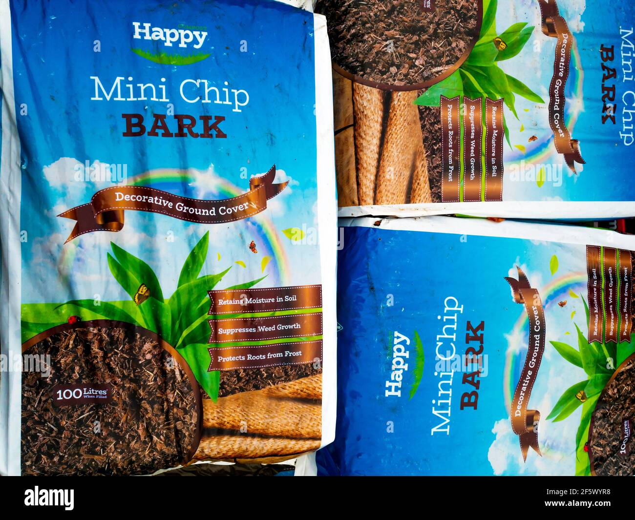 A stack of bags of Mini Chip Bark in a garden centre, for dressing ...