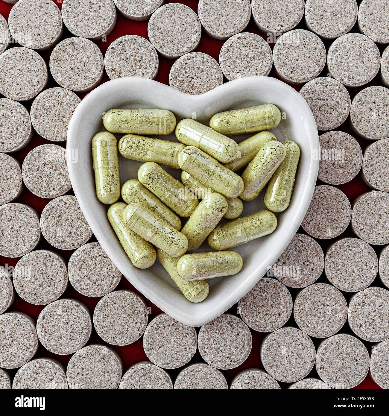 dietary concept. heart shaped white porcelain bowl full of rutin ...