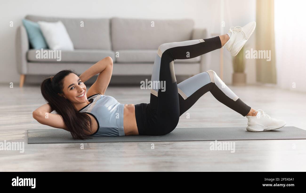 Woman exercise home crunches hi-res stock photography and images - Alamy