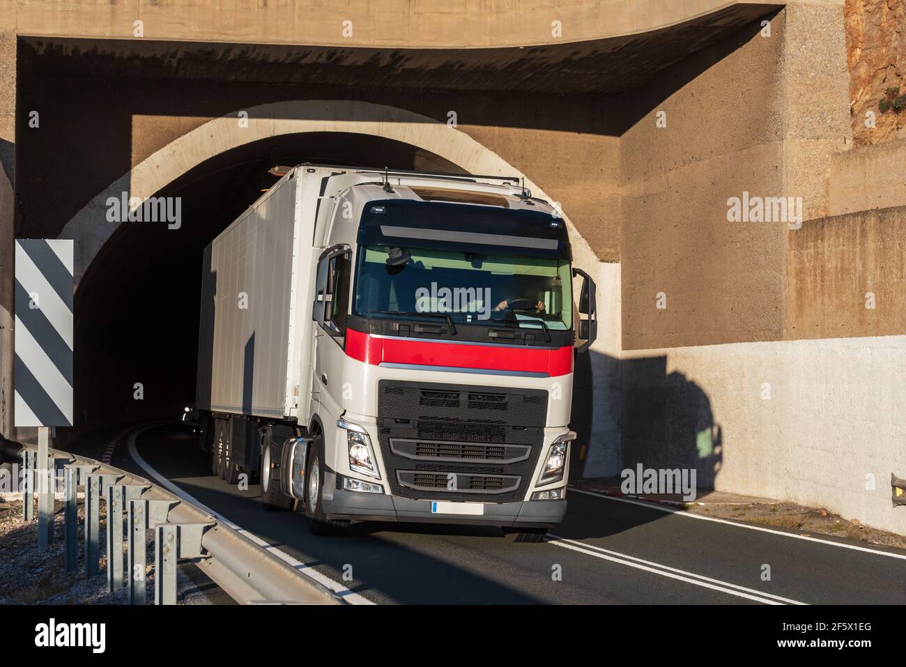 Truck with refrigerated semi-trailer leaving the tunnel of a ...