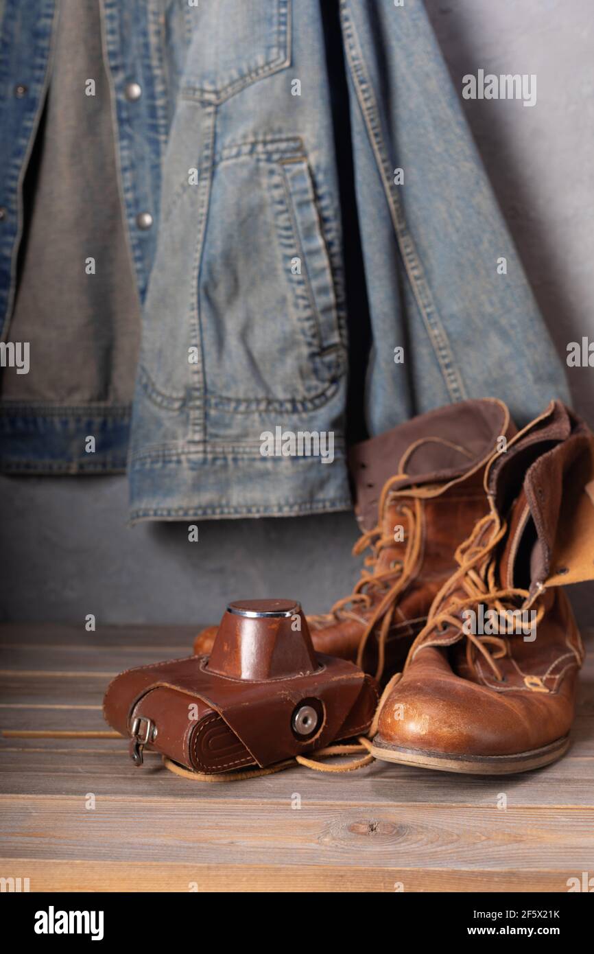 travel vintage old boots shoes at wooden table and retro camera ...