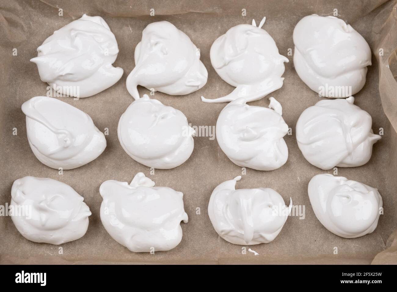 meringue on parchment paper cooking process Stock Photo - Alamy