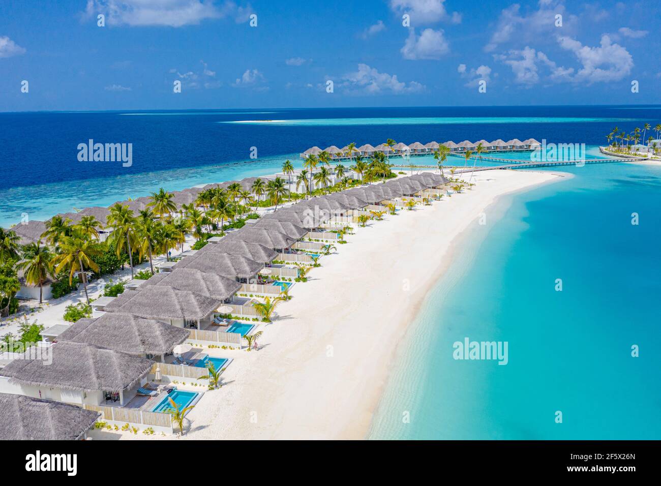 Aerial view of Maldives island, luxury water villas resort and wooden ...