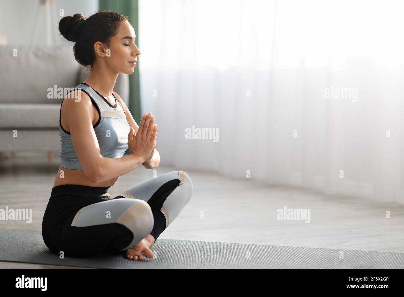 Young pretty woman meditating sitting hi-res stock photography and ...