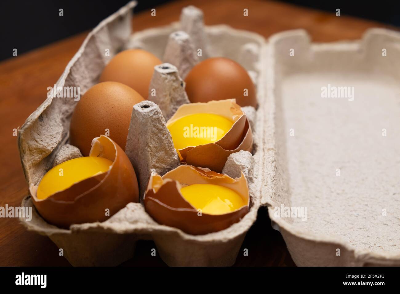 broken eggs in the tray,separation of protein from yolks Stock Photo ...