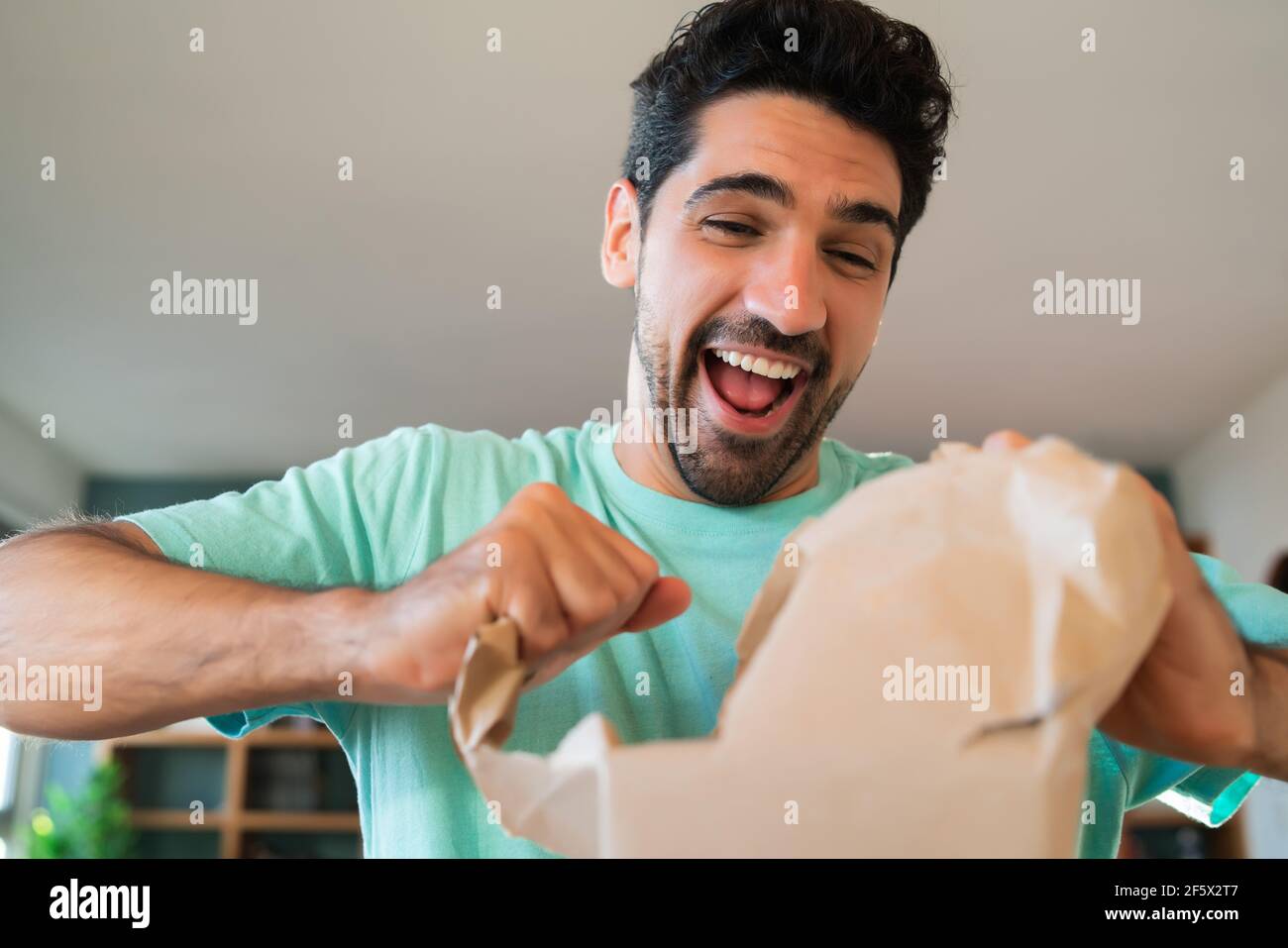 Surprised man opening a gift box Stock Photo - Alamy