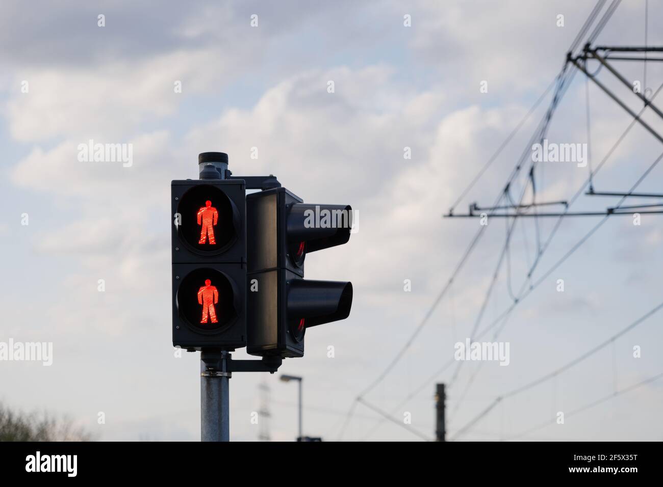 Low angle view, traffic light with red human symbol to stop walking ...