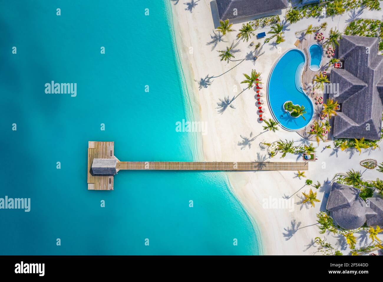 Aerial view of Maldives island, luxury water villas resort and wooden ...
