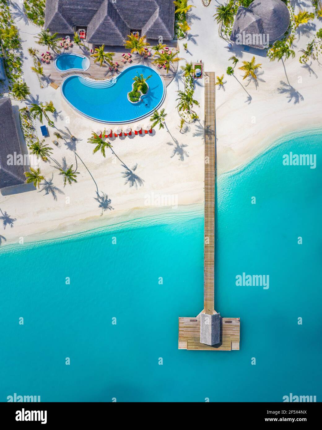 Aerial view of Maldives island, luxury water villas resort and wooden ...