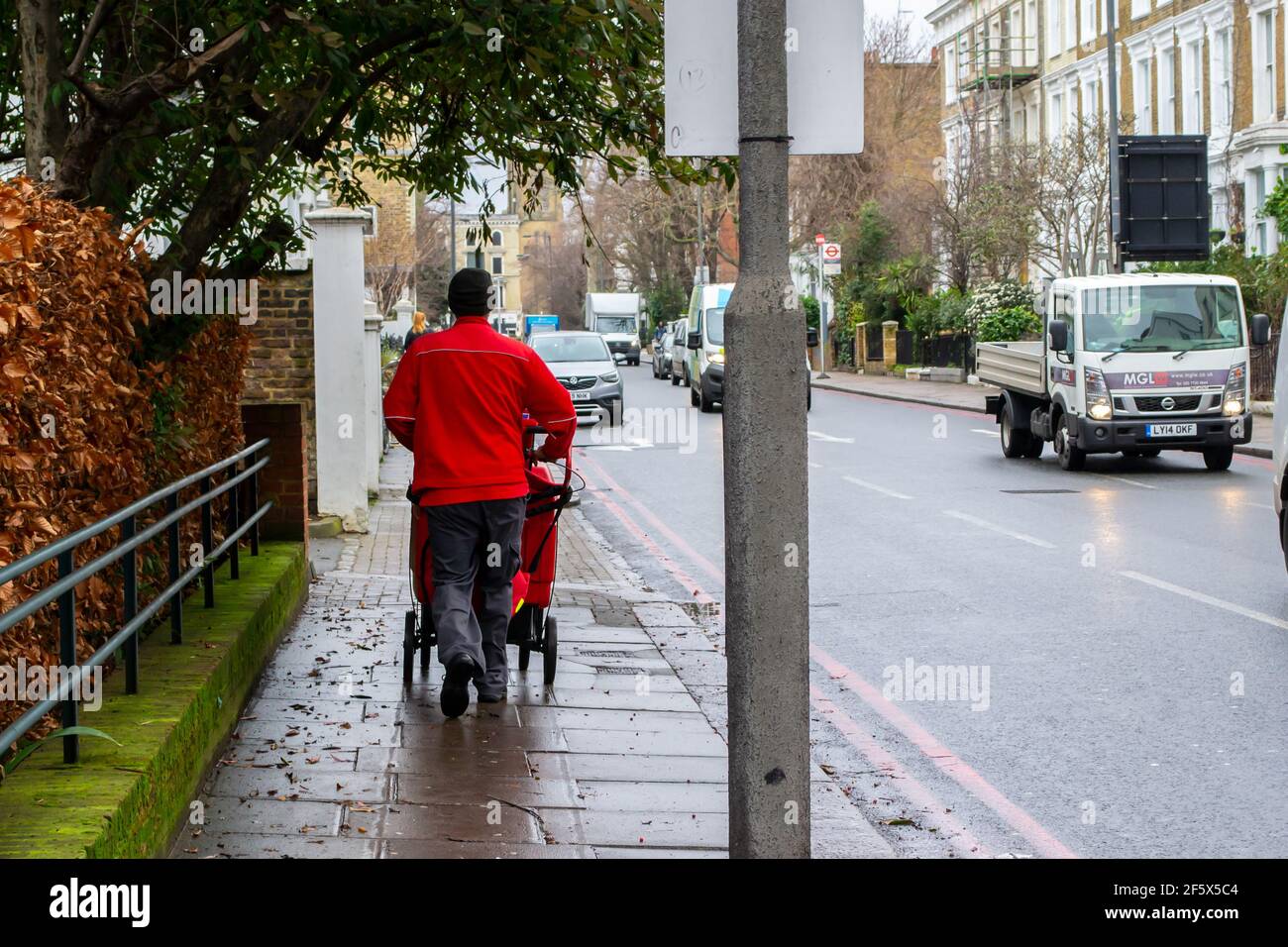 Postman pushing mail trolley hi-res stock photography and images - Alamy