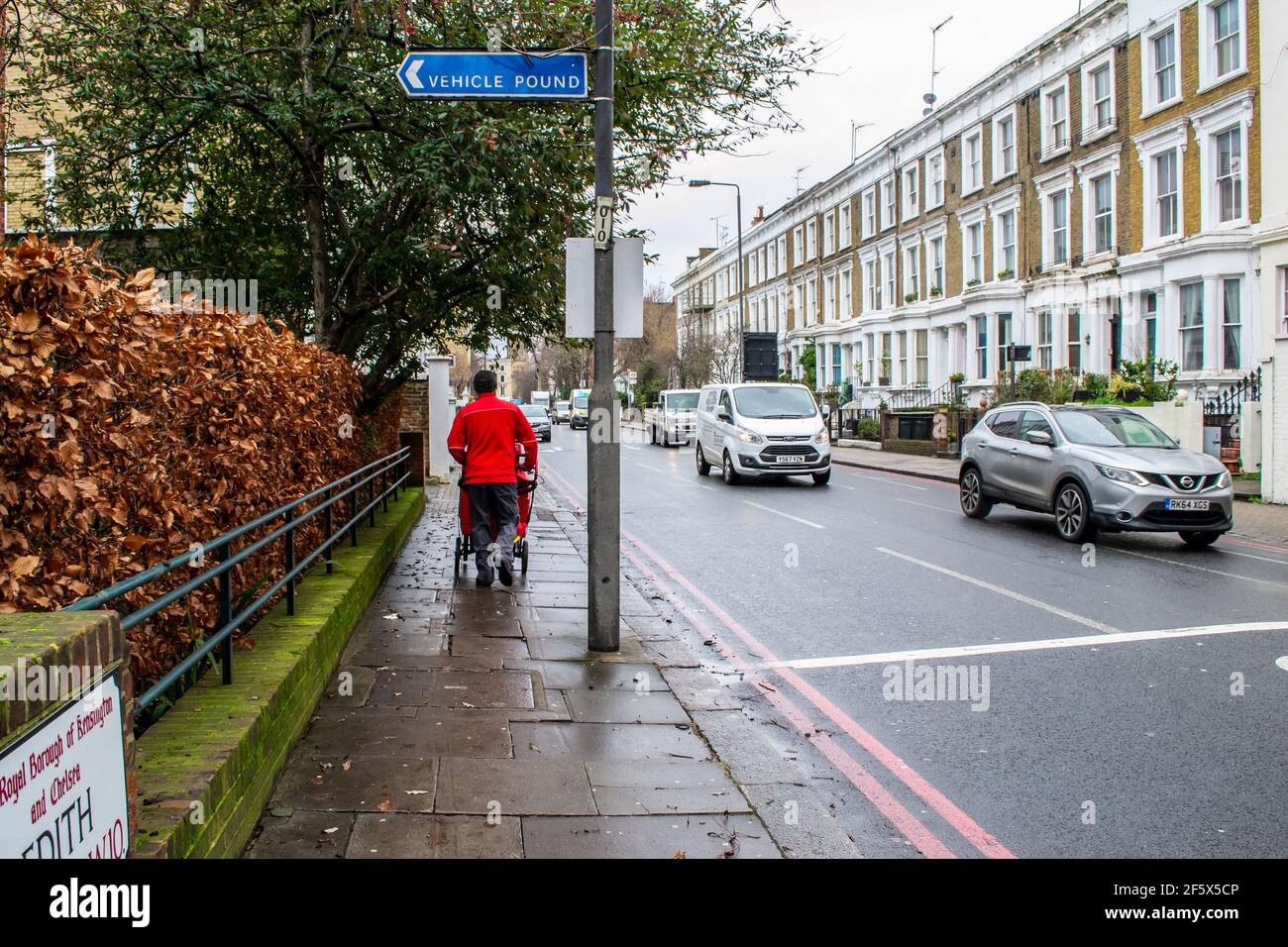 Postman pushing mail trolley hi-res stock photography and images - Alamy