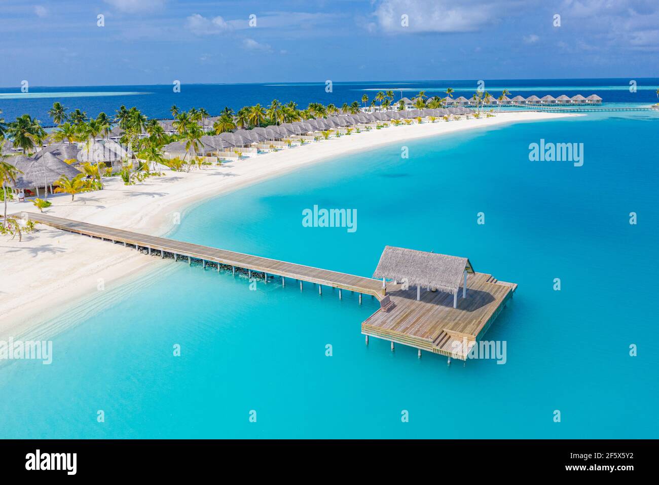 Aerial view of Maldives island, luxury water villas resort and wooden ...