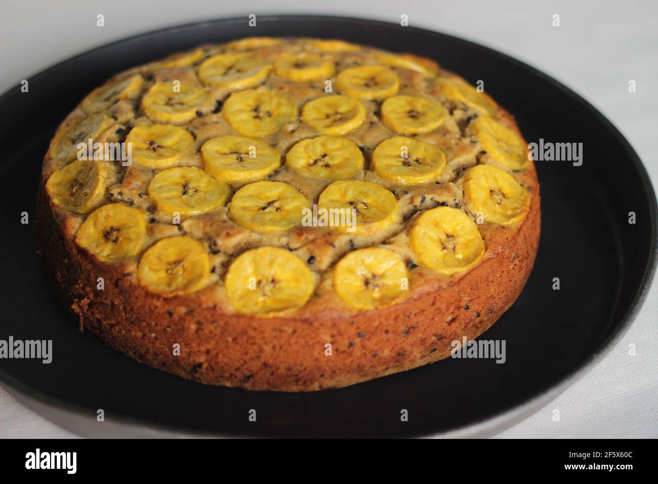 Home baked Plantain cake with sliced plantain as a topping. Shot on ...