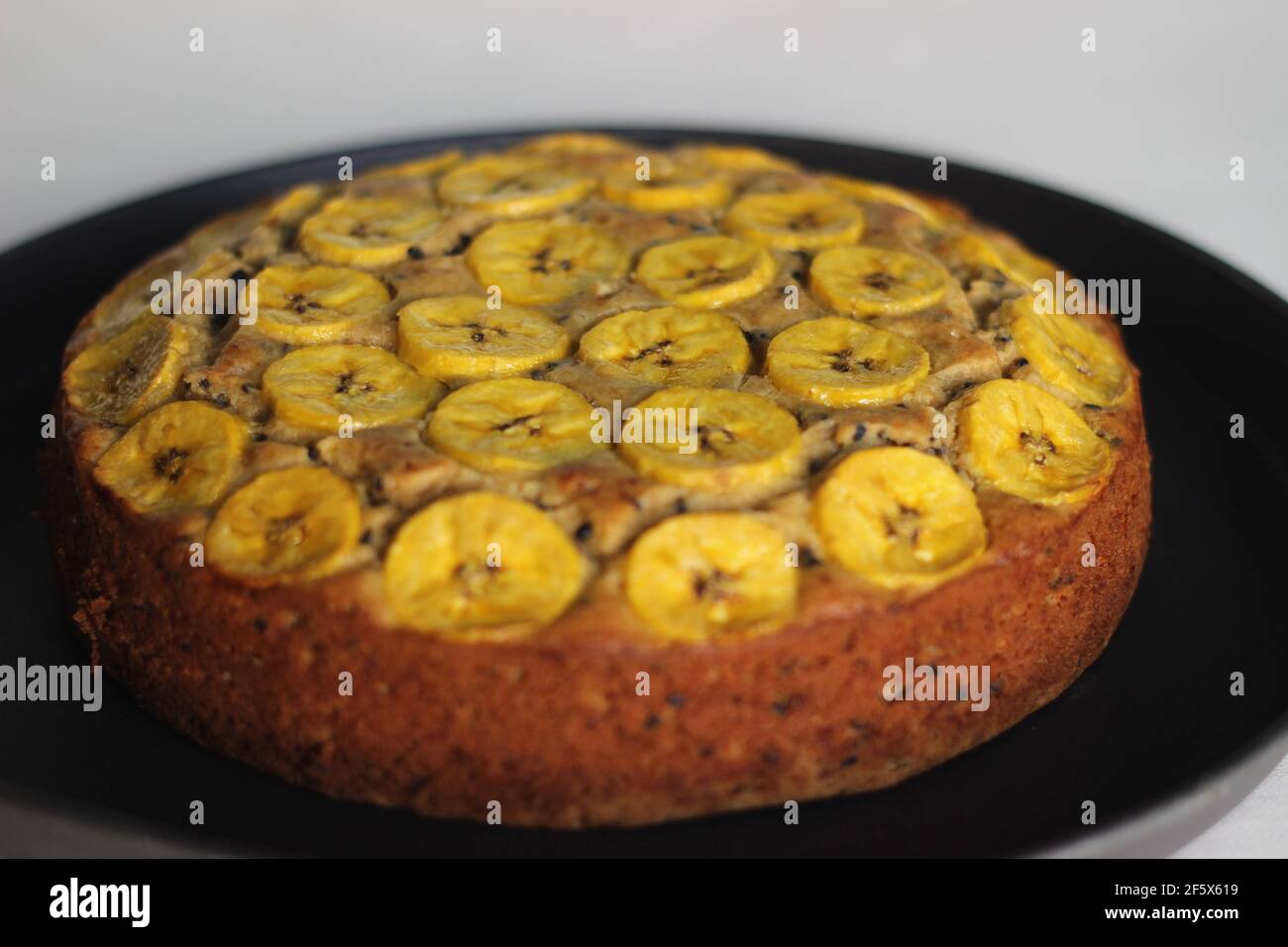 Home baked Plantain cake with sliced plantain as a topping. Shot on ...