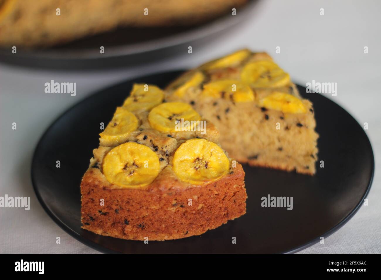 Slices of home baked plantain cake with plantain pieces as a topping ...