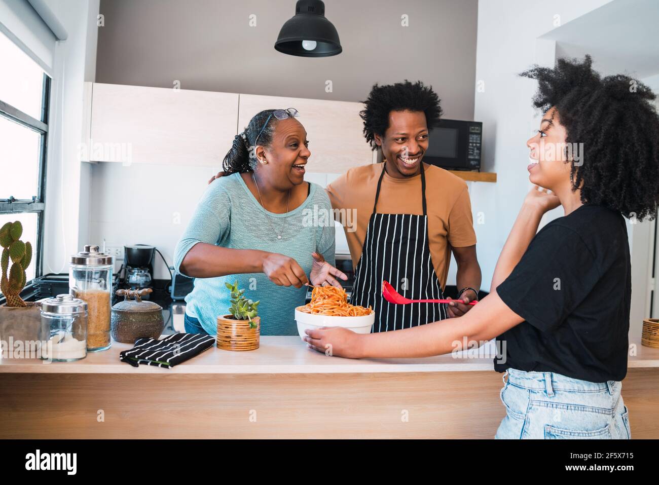 Portrait of family cook together at home Stock Photo - Alamy
