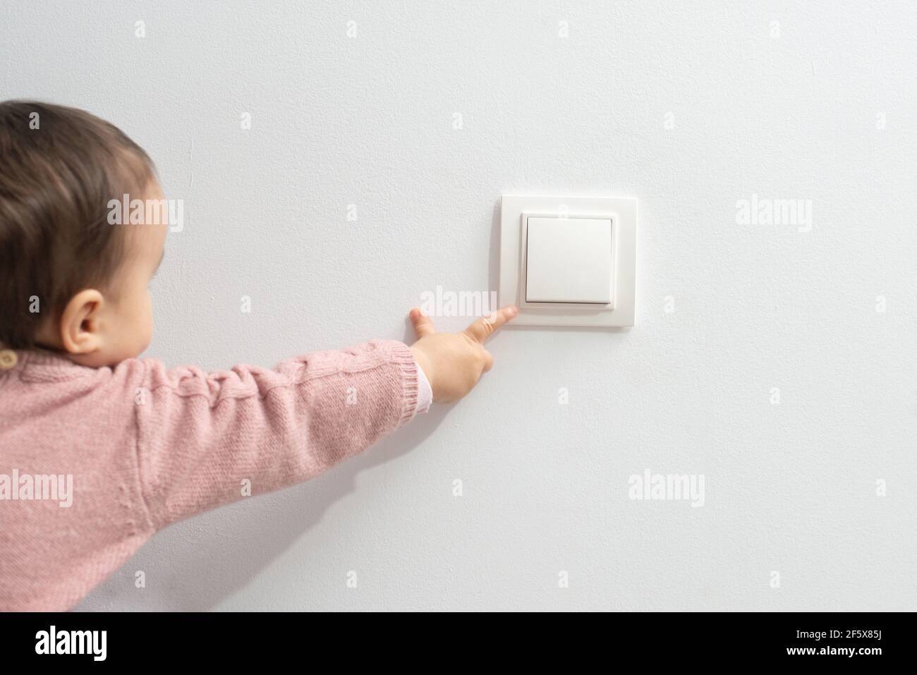 Little child playing with switch Stock Photo - Alamy