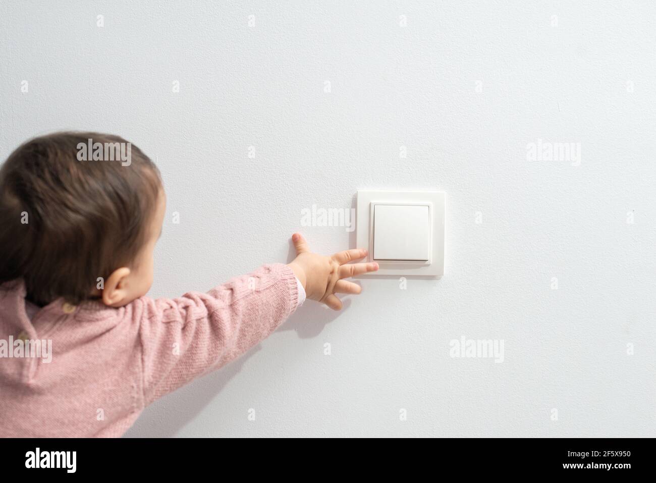 Little child playing with switch Stock Photo - Alamy