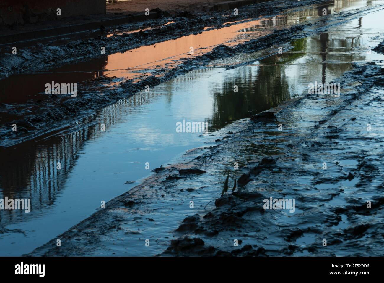 Road covered with mud after flooding the river, covered with mud and ...
