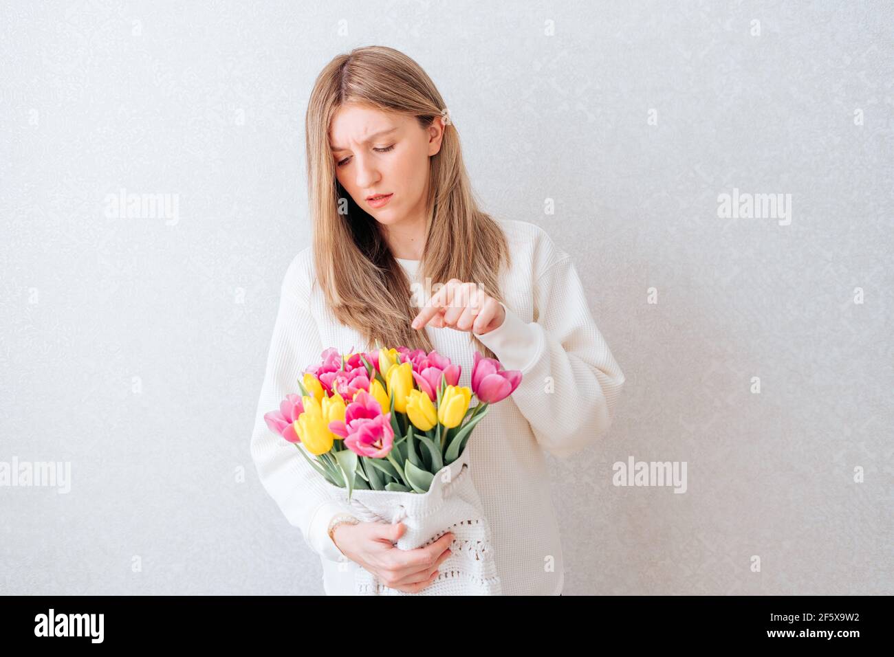 Sad woman holding tulips Stock Photo - Alamy