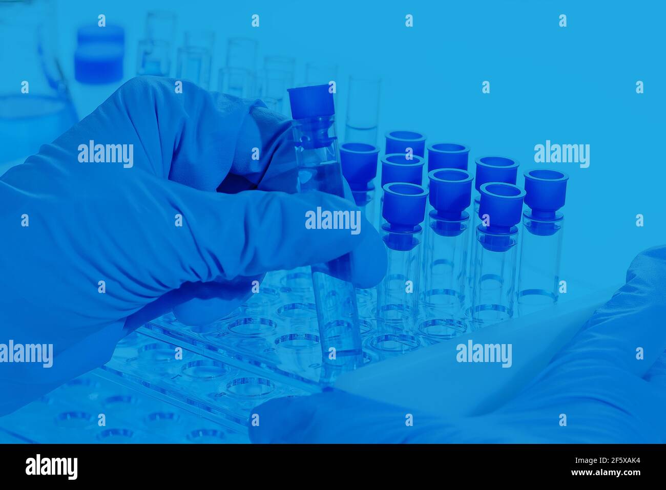 The dropper fills the sample vials for testing. Pharmaceutical ...