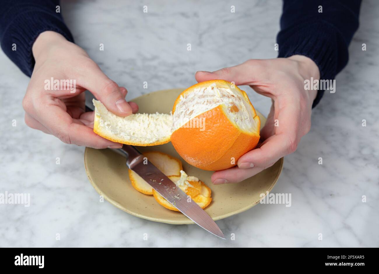 Man's hands peeling an orange. Healthy food concept Stock Photo - Alamy