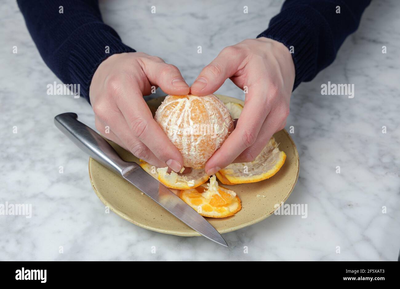 Man's hands peeling an orange. Healthy food concept Stock Photo - Alamy