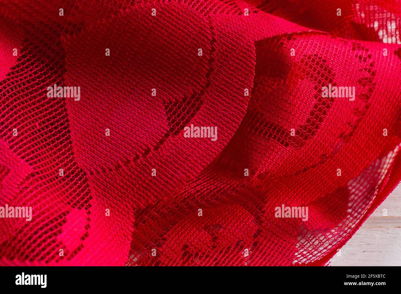 A luxurious red mesh fabric, useful for backgrounds. Red fabric mesh in ...