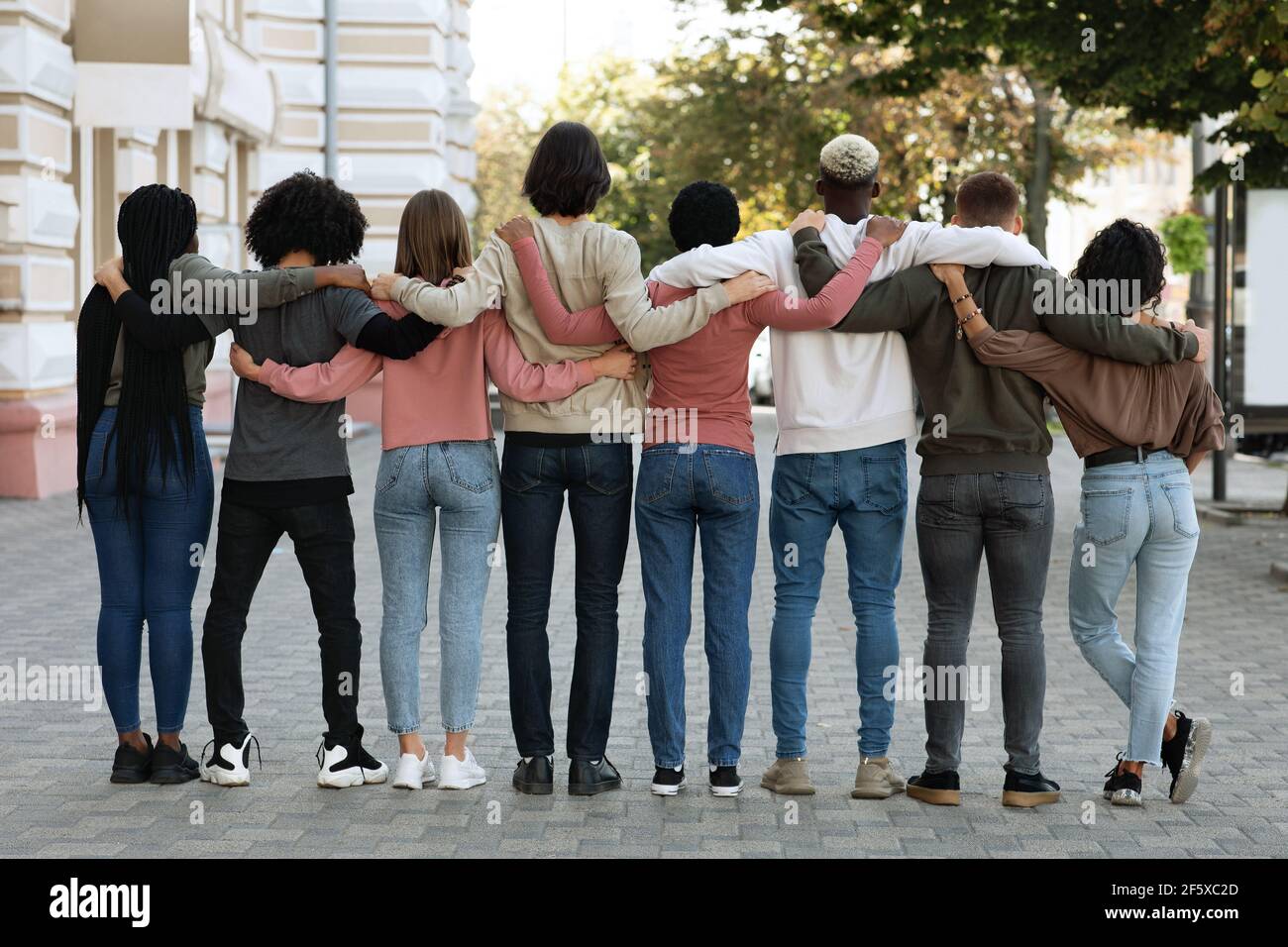 Friends hug rear view hi-res stock photography and images - Alamy