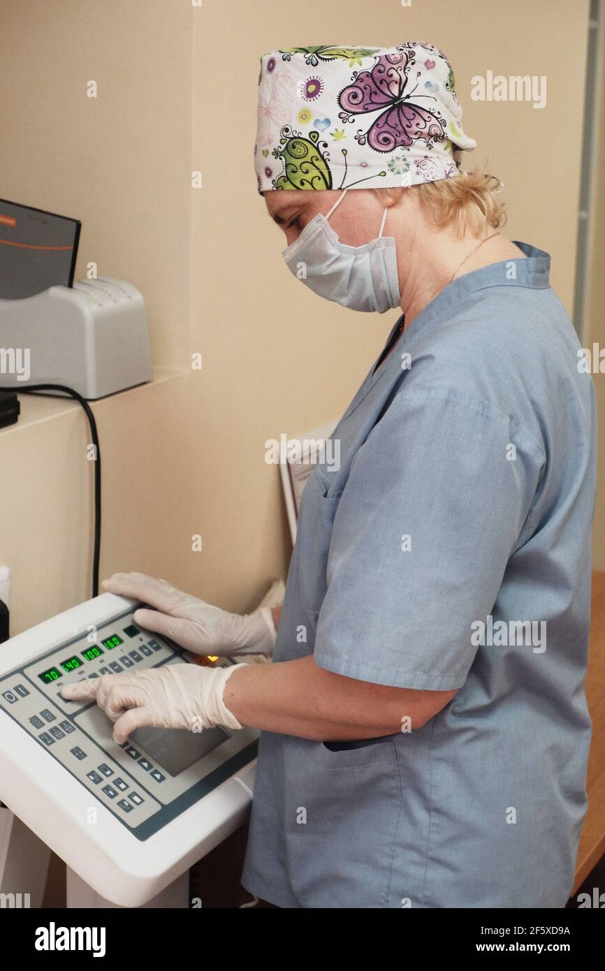 A woman radiologist at the X-ray apparatus is conducting diagnostic ...
