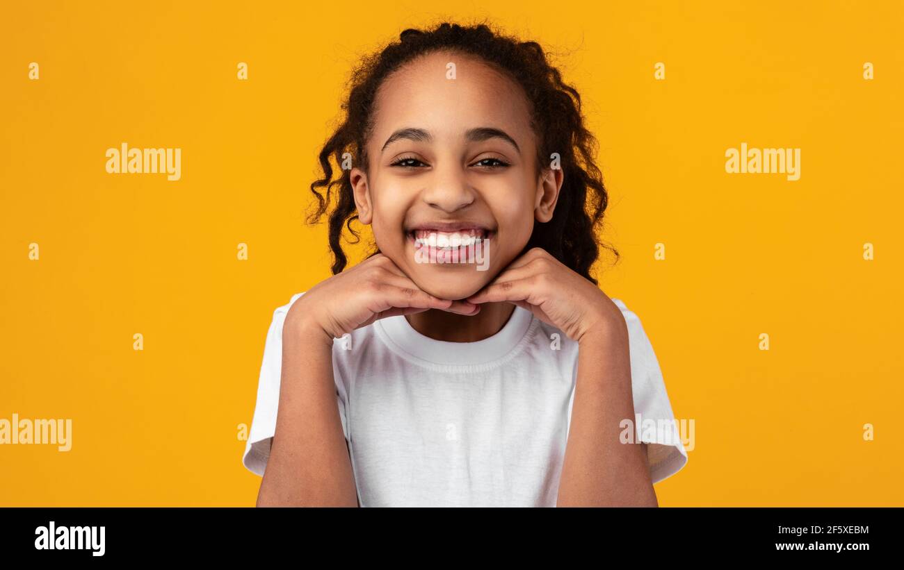 Cute Joyful African American Girl Leaning Chin On Hands Stock Photo - Alamy