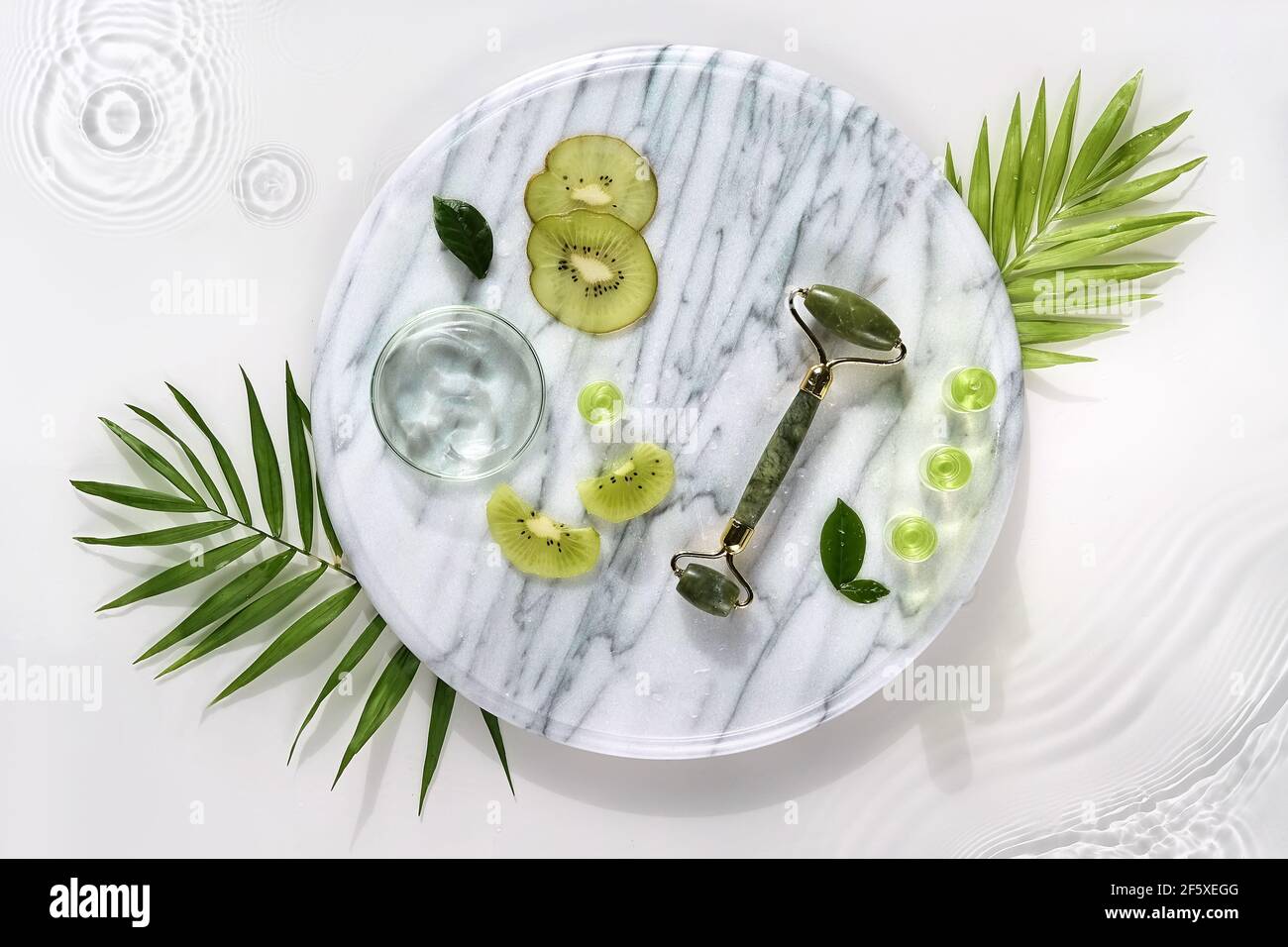 Cosmetic skincare background. Herbal medicine with kiwi slices, palm ...