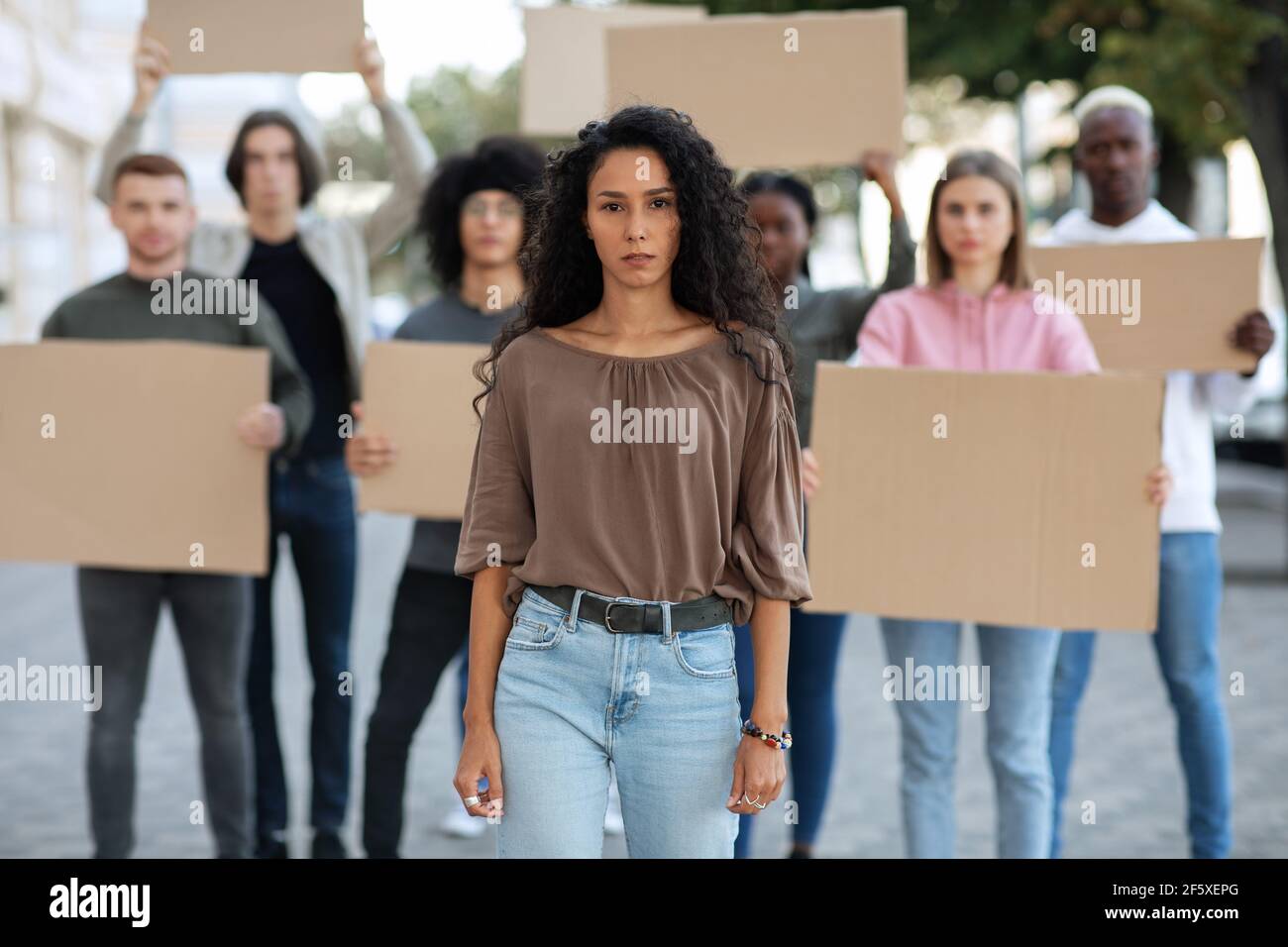 Active woman leading a group of demonstrators on the street Stock Photo ...