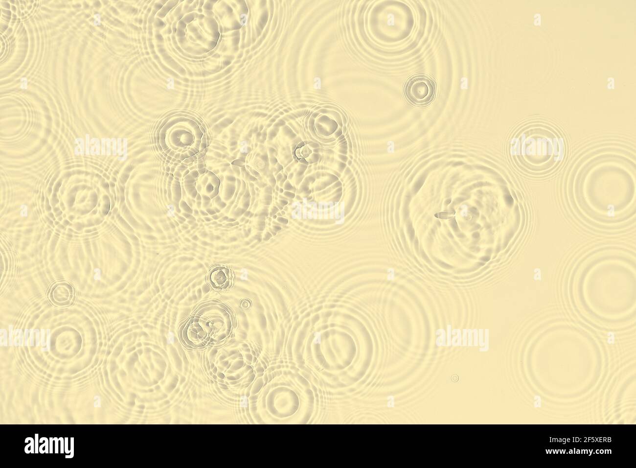 Water background. Yellow water texture, disturbed surface with rings ...