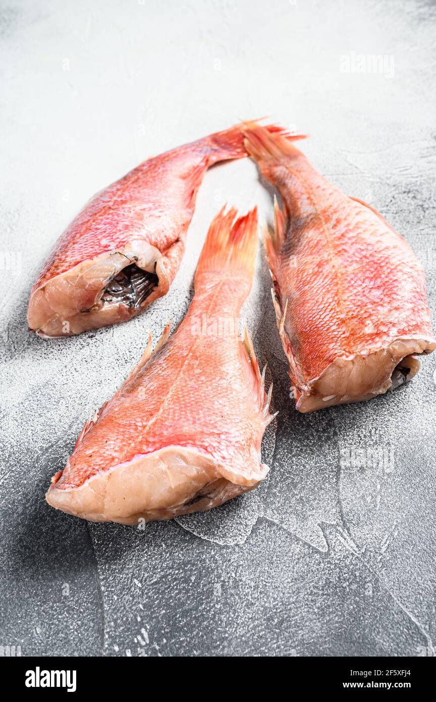 Raw Red perch or seabass fish. White background. Top view Stock Photo ...