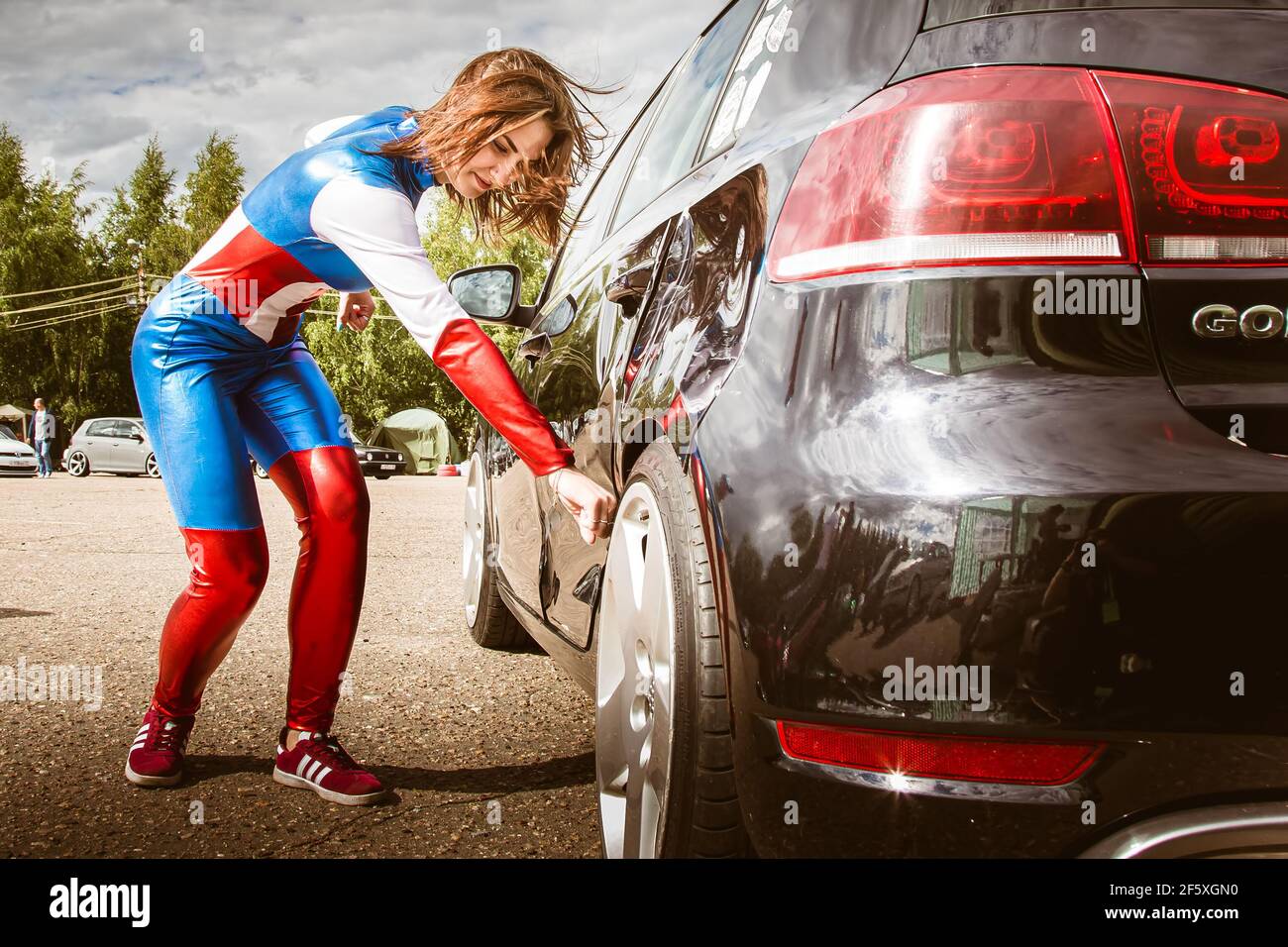Moscow, Russia - July 06, 2020: Woman Captain America. He hits the car ...