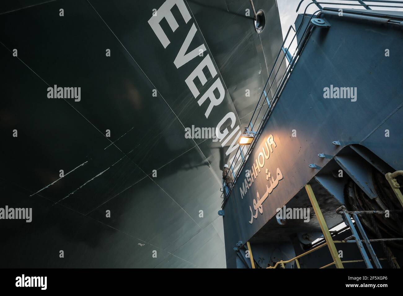 HANDOUT - 28 March 2021, Egypt, Suez: Naval dredger "Mashhour" (R ...