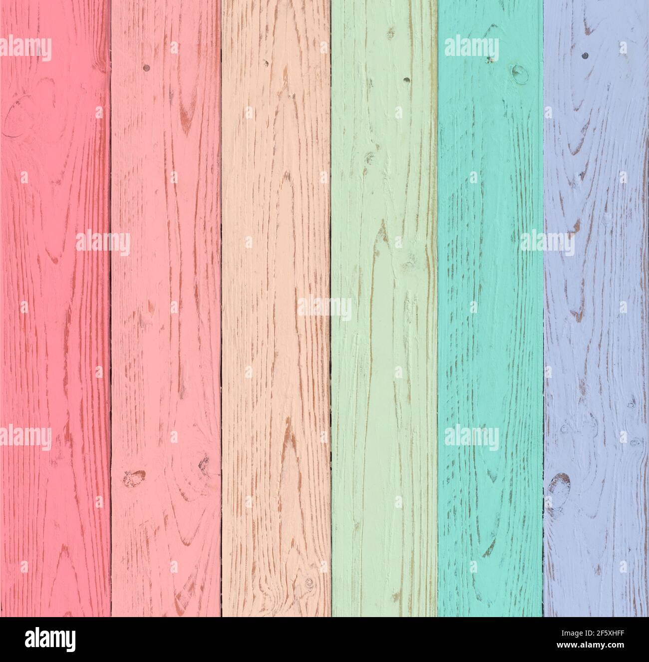 A rustic looking wooden boards painted in pastel shades of red, pink ...