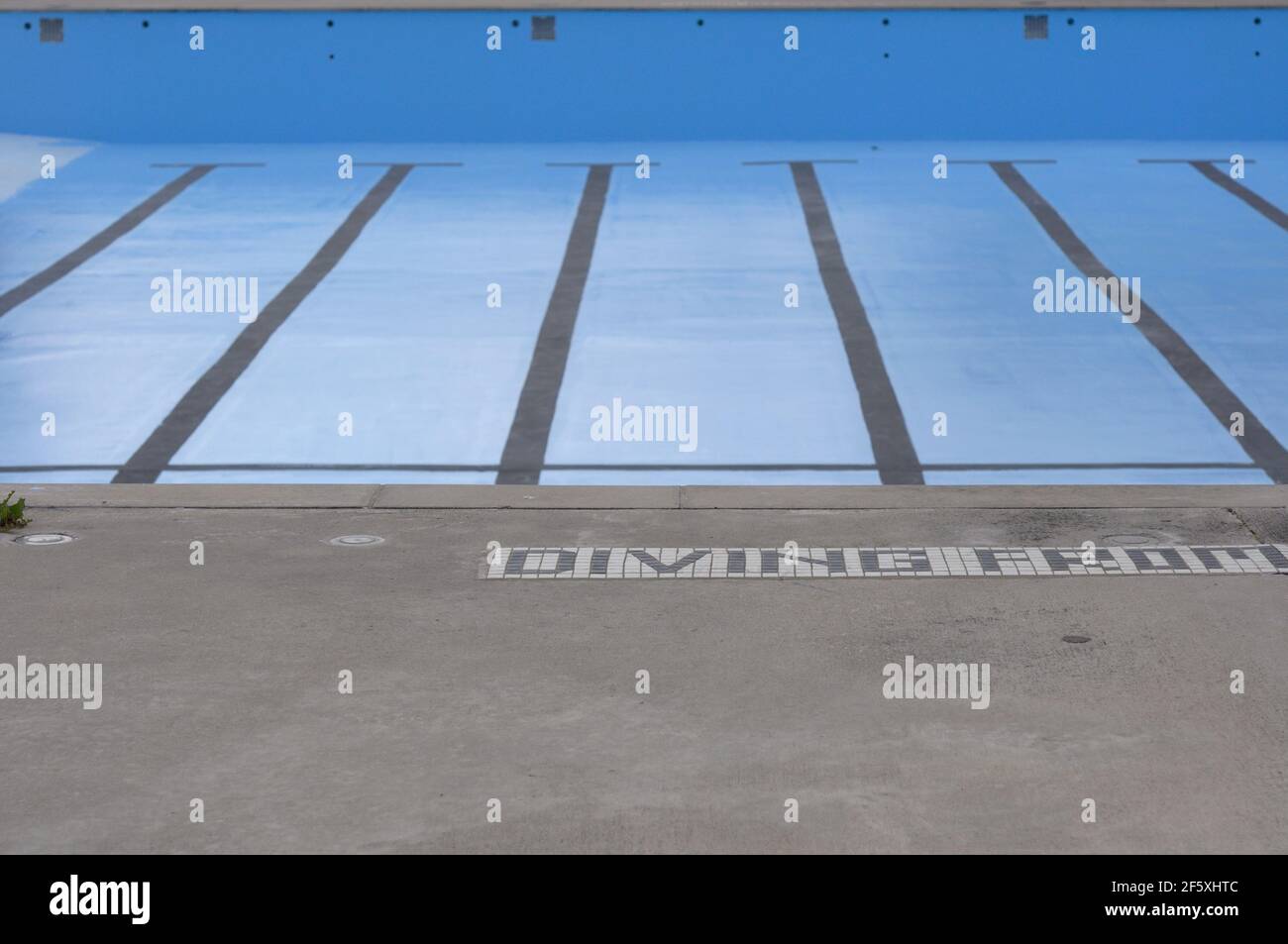 outdoor swimming pool, without water, with black lane marking visible ...