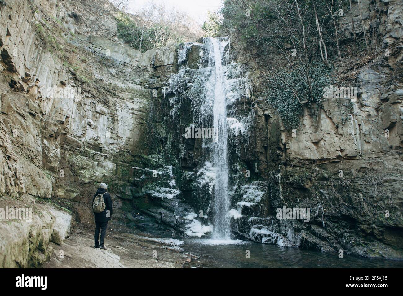 Winter landscape with ice waterfall in Tbilisi, Georgia. A tourist ...