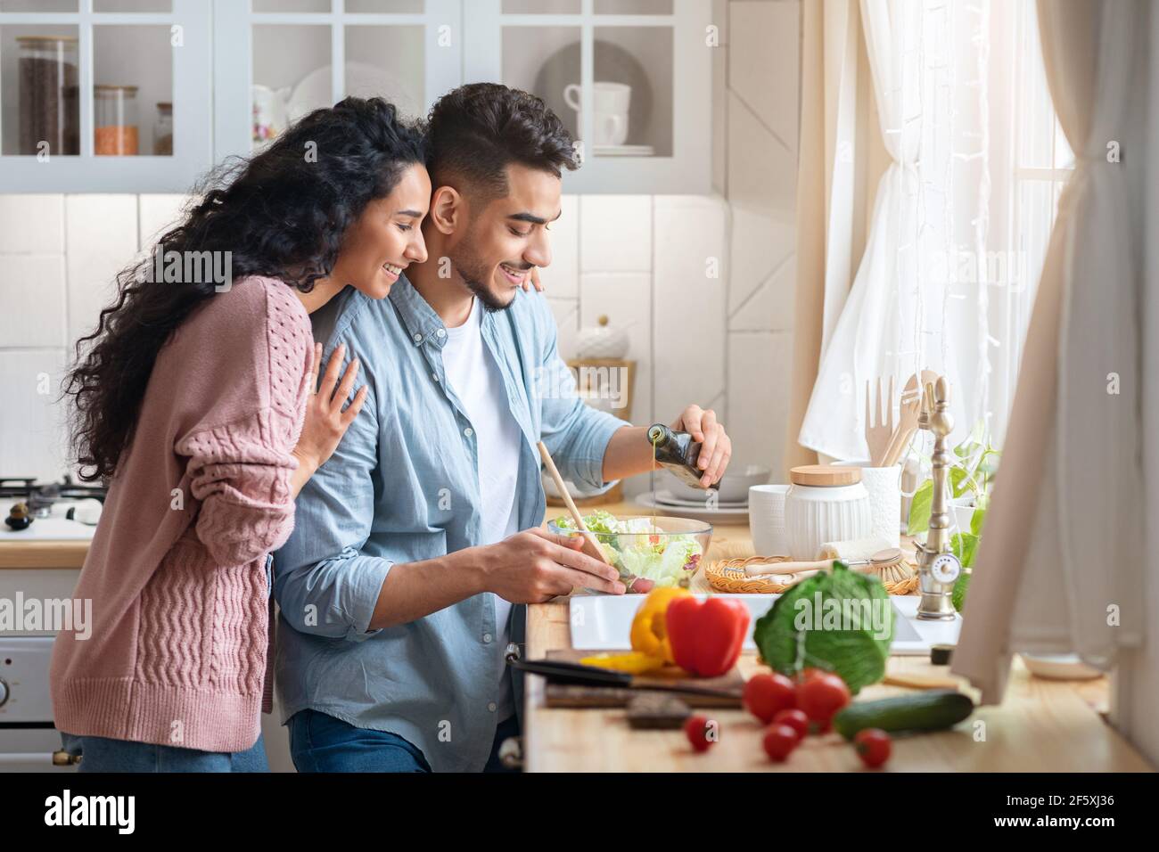 Modern muslim couple cooking healthy food in kitchen at home together ...