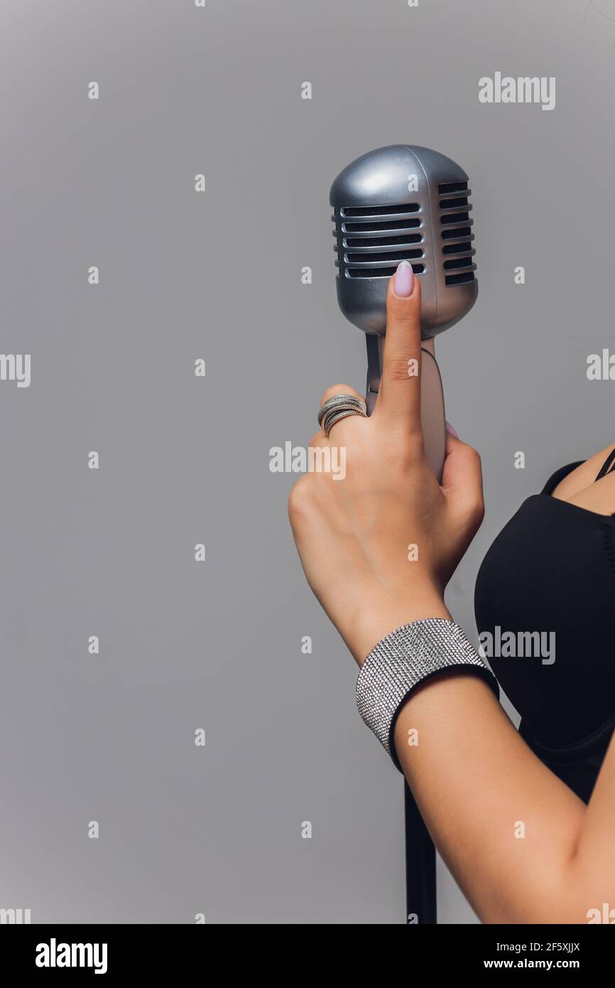 Female hand holding a microphone isolated on white background, clipping ...