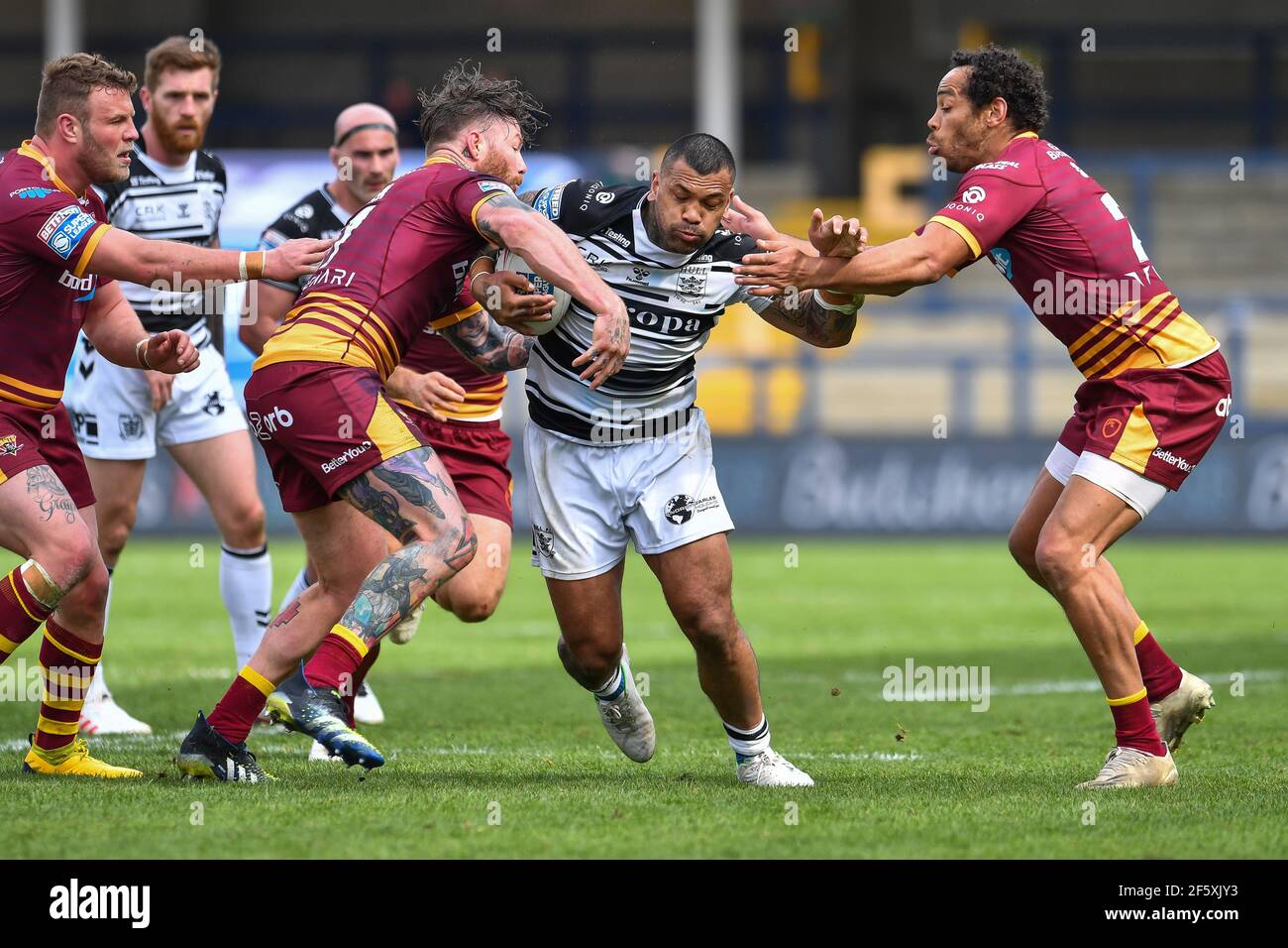 Manu Ma'u (12) of Hull FC is tackled by Chris McQueen (17) and Leroy ...