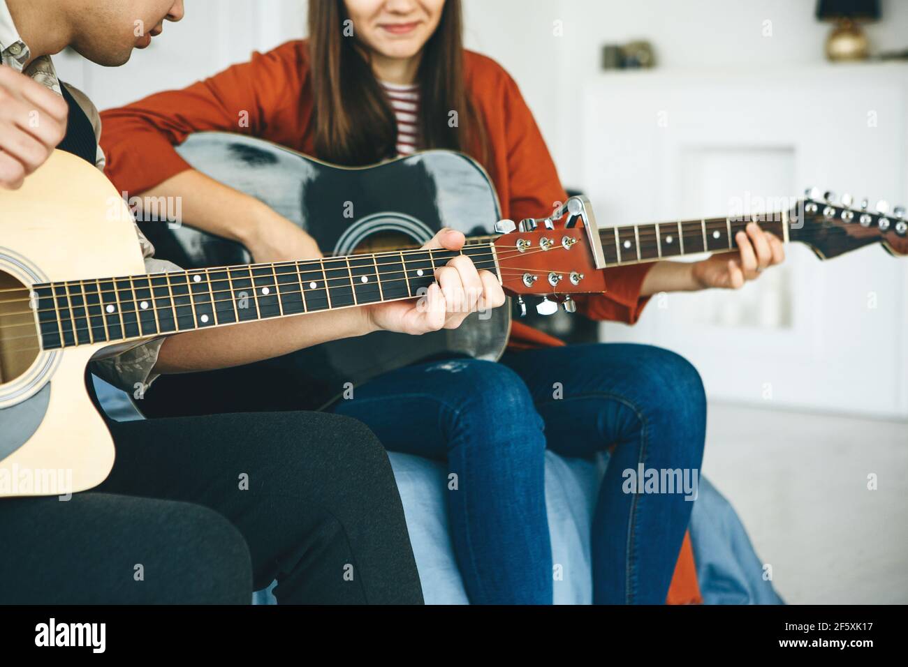 Learning to play the guitar. The teacher explains to the student the ...
