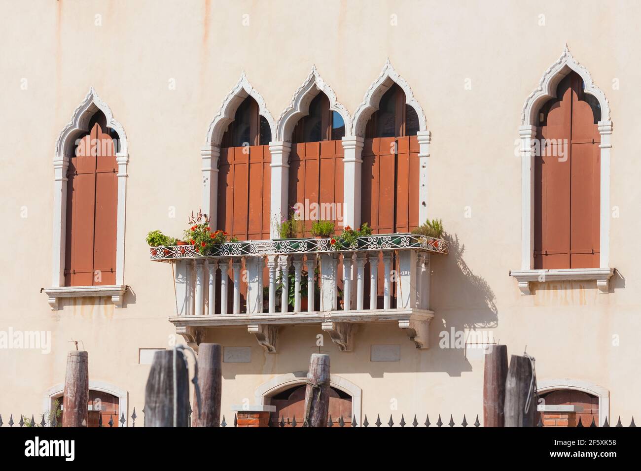 Facade of venetian house with typical old venetian windows with closed ...