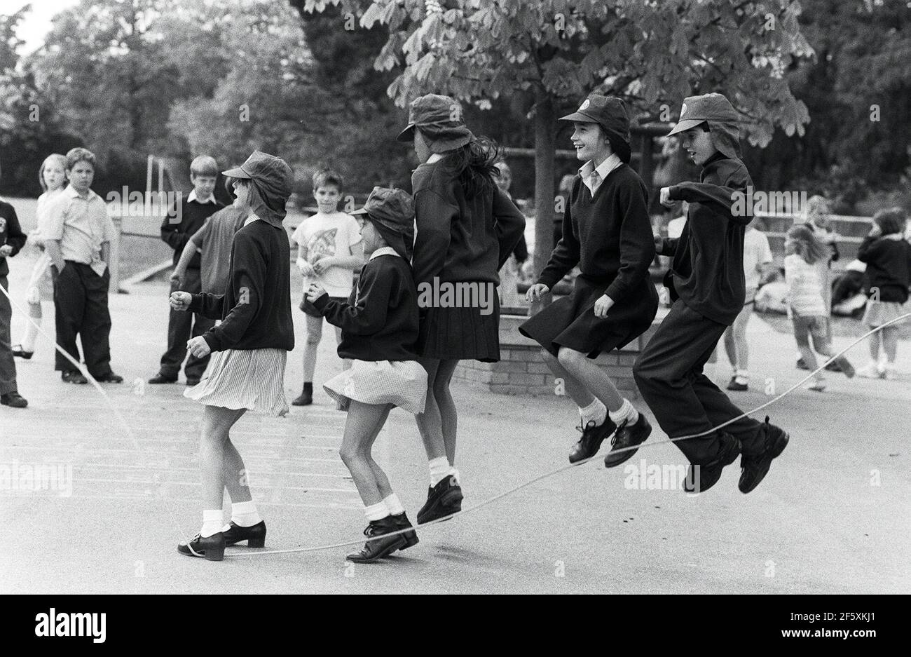 Some young lively schoolgirls go wild in the playground at break ...