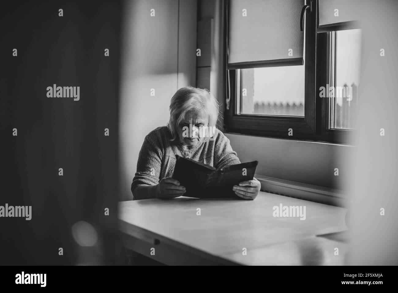 Old woman spending time alone with god, praying and reading bible Stock ...