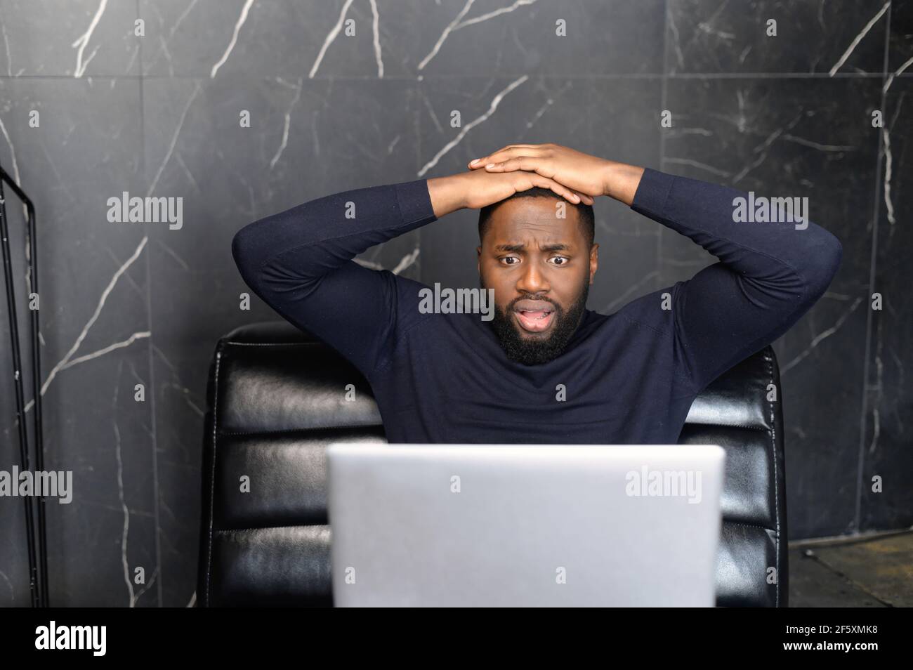 Oh no. Portrait of shocked black businessman holding hands on head ...