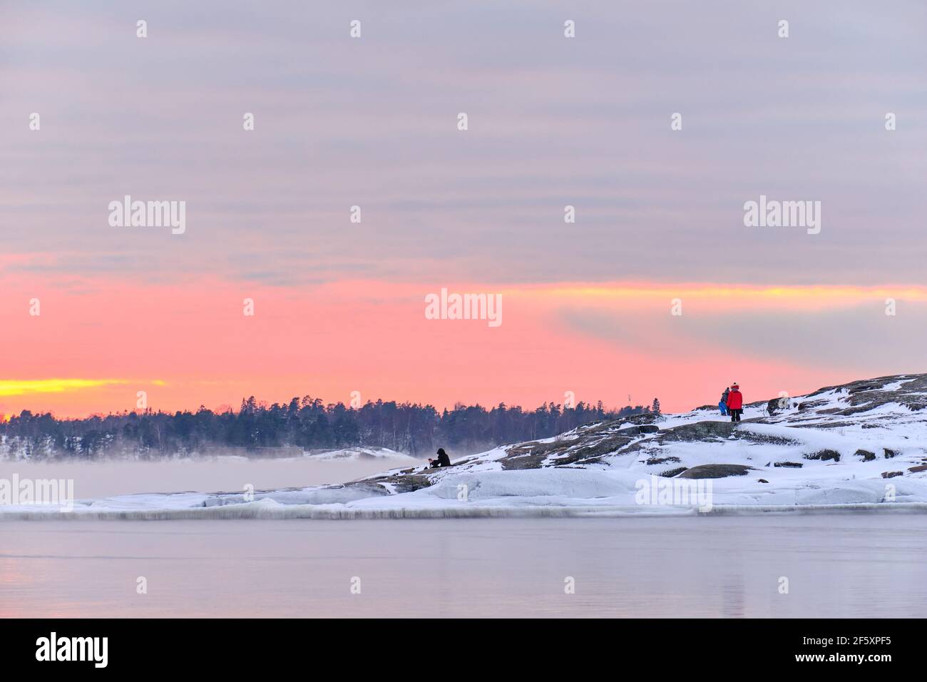 Ice-covered Baltic seashore in Finland. Fog over the sea during a ...