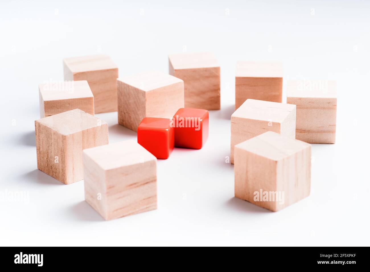 Wooden and red plastic cubes on a white background. Many wooden cubes ...